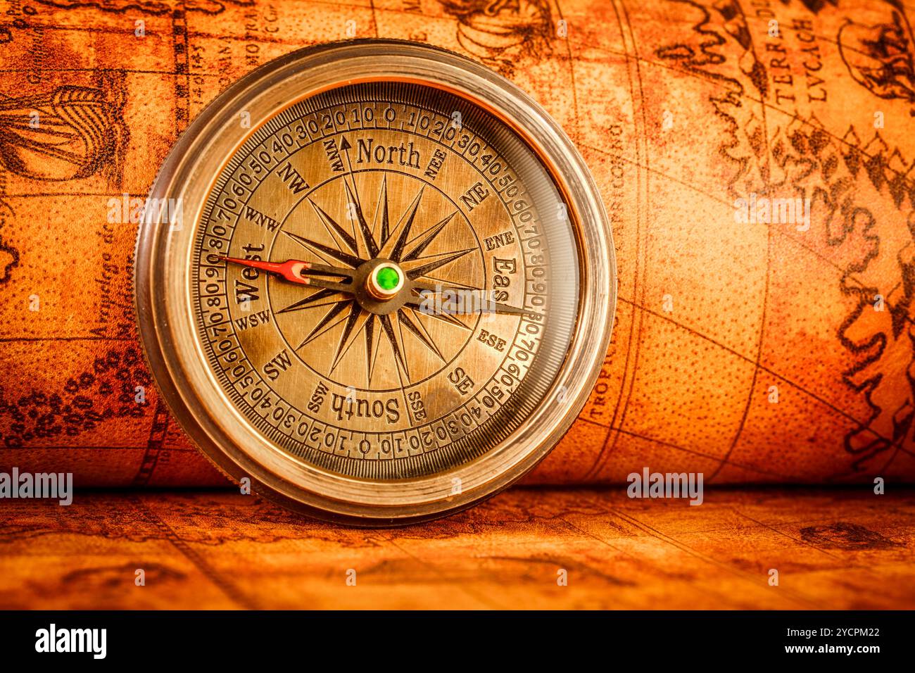 Vintage compass lies on an ancient world map Stock Photo - Alamy