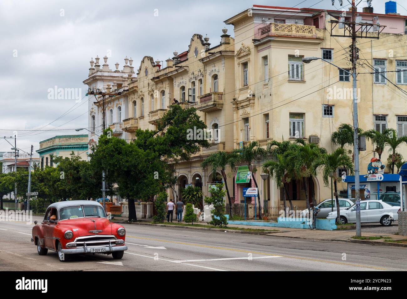A Typical red vintage 50s car in front of a historical building in La ...