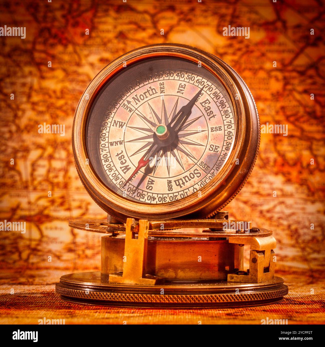 Vintage compass lies on an ancient world map Stock Photo - Alamy