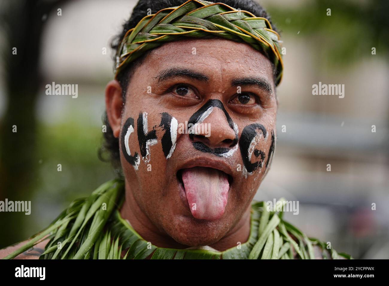 A Samoan man with Commonwealth Heads of Government Meeting written on ...