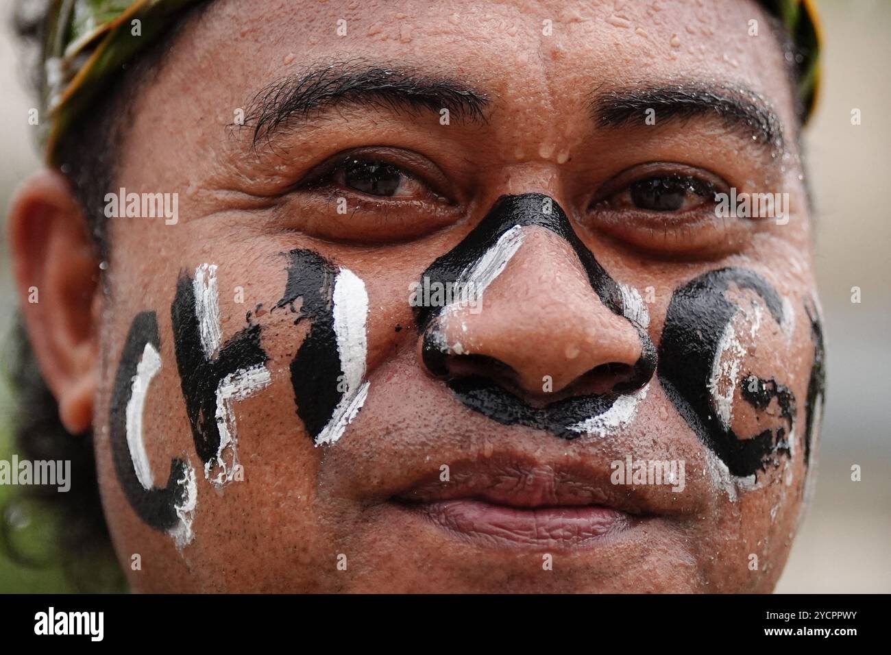 A Samoan man with Commonwealth Heads of Government Meeting written on ...