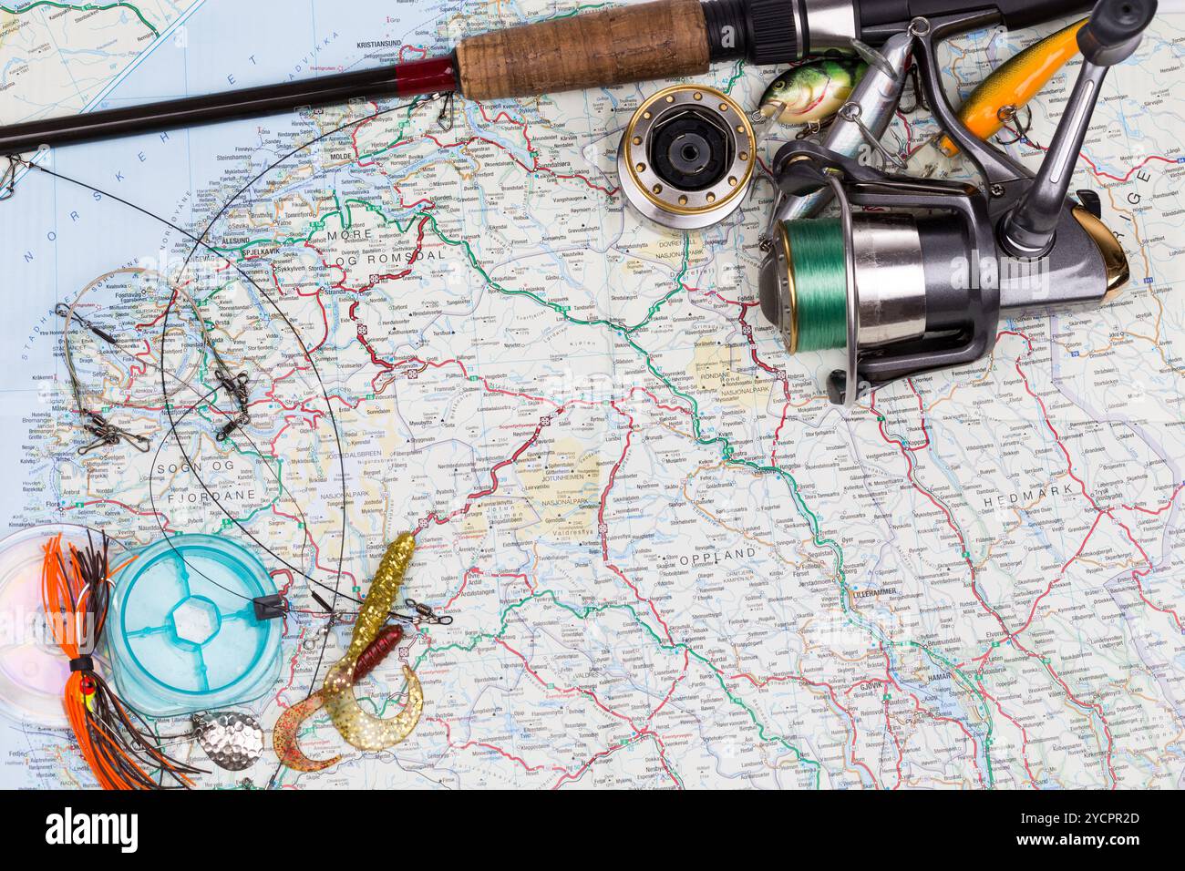 Fishing tackles - rod, reel, line and lure on map Stock Photo - Alamy
