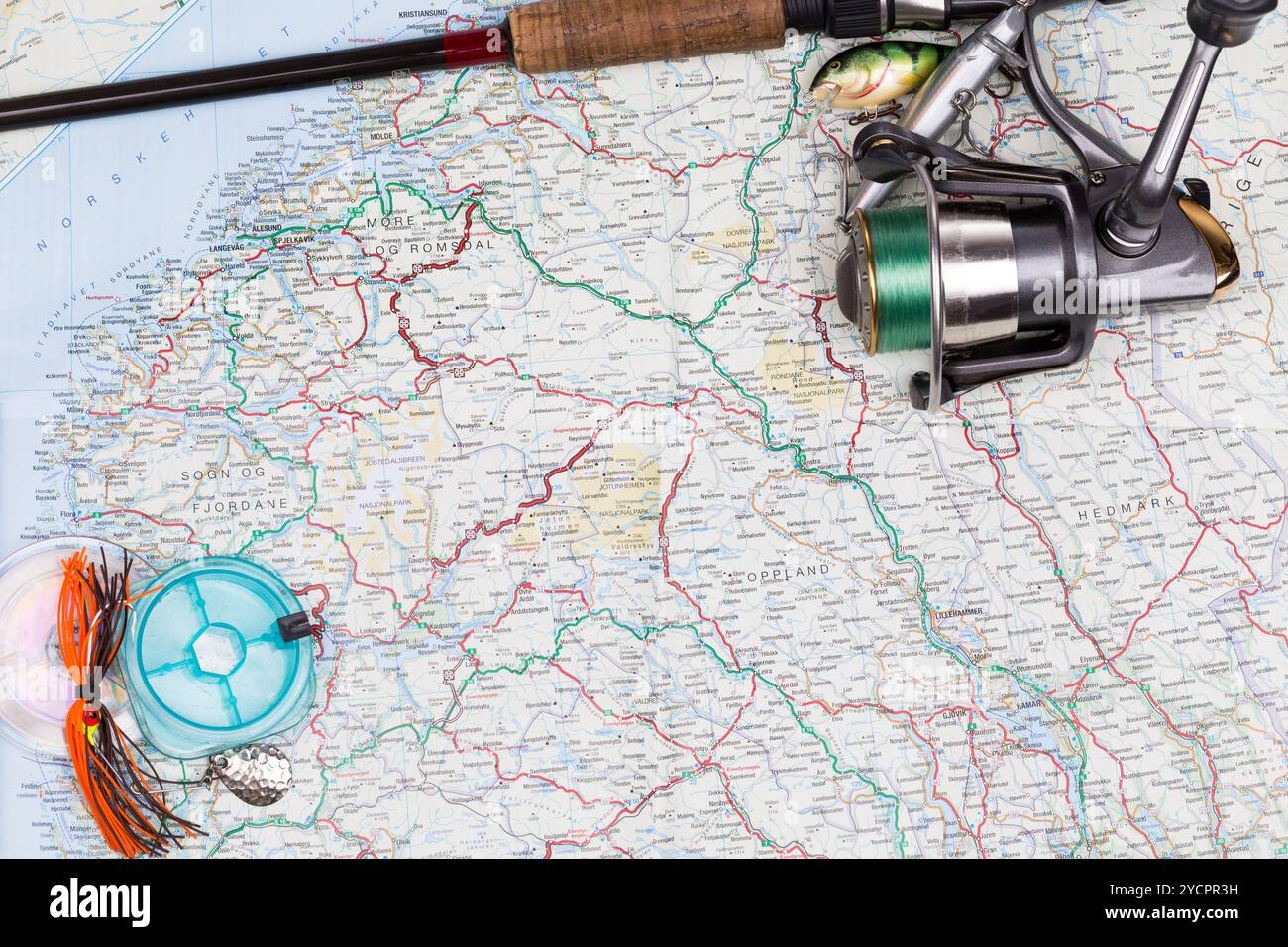 Fishing tackles - rod, reel, line and lure on map Stock Photo - Alamy