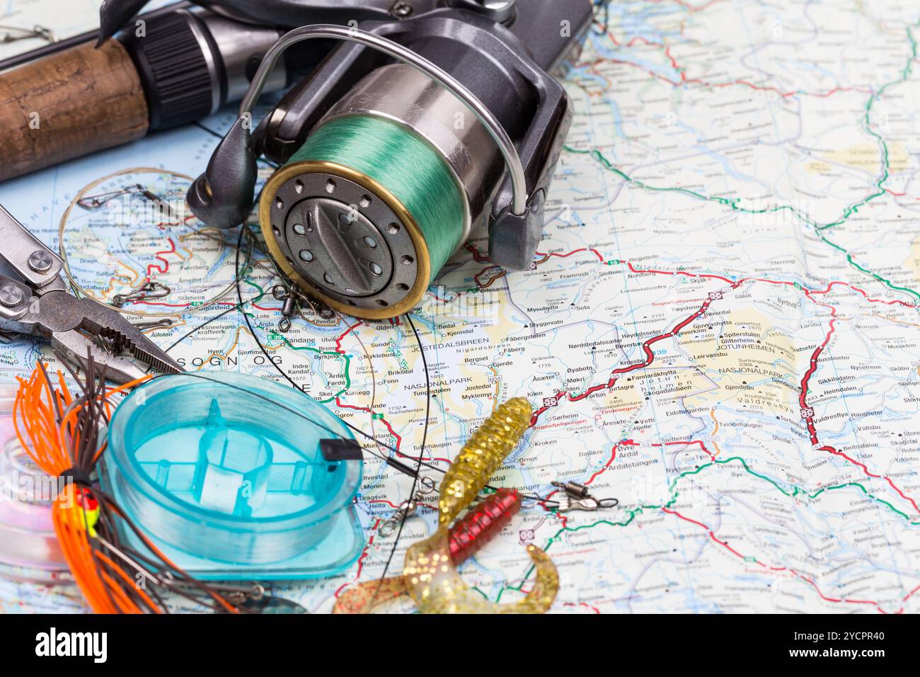 Fishing tackles - rod, reel, line and lure on map Stock Photo - Alamy
