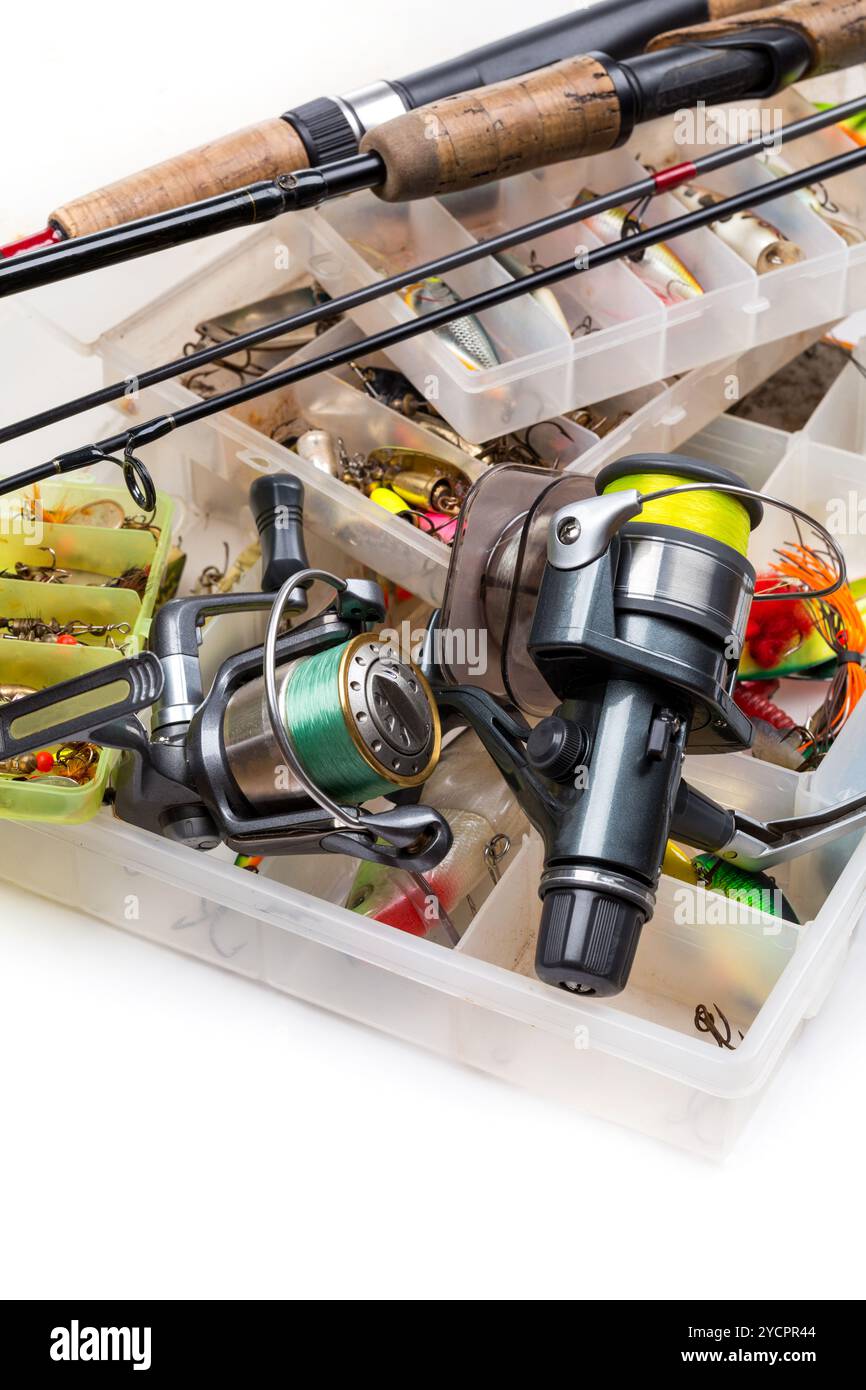 different fishing tackles - rod, reel, line and lures in box on white ...
