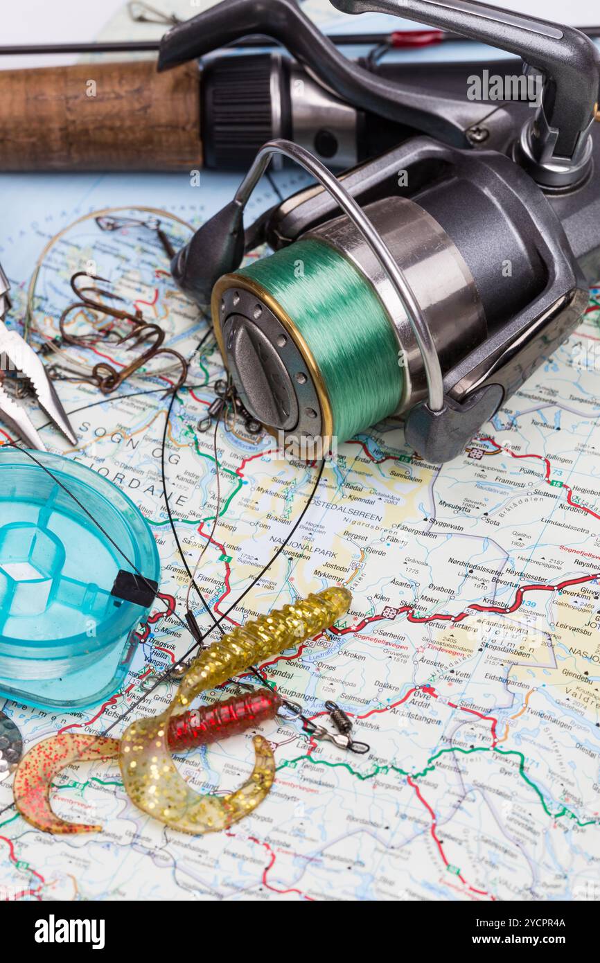 Fishing tackles - rod, reel, line and lure on map Stock Photo - Alamy