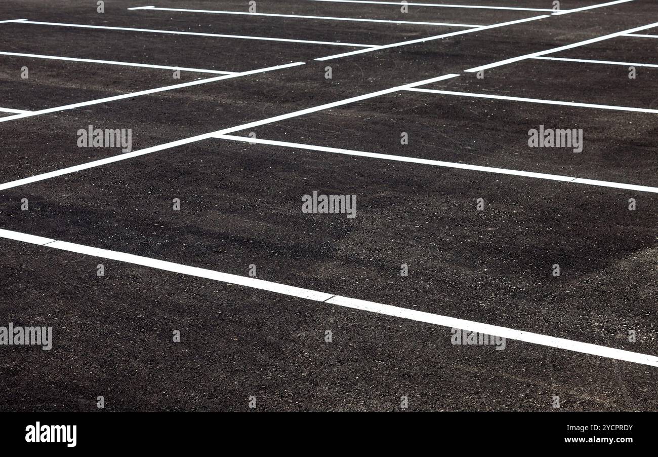 White traffic markings on a gray asphalt parking lot Stock Photo - Alamy