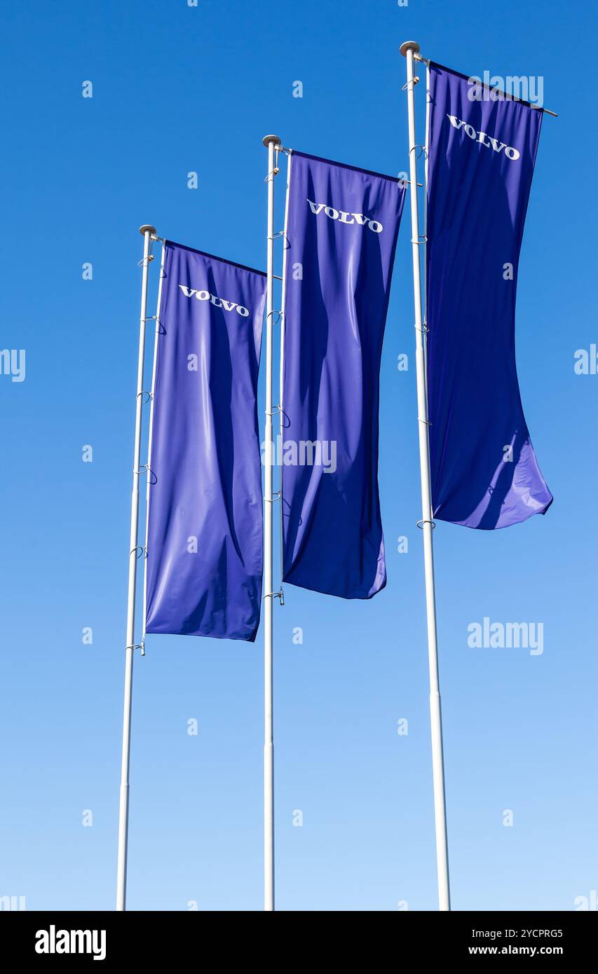 Volvo dealership flags over blue sky Stock Photo - Alamy