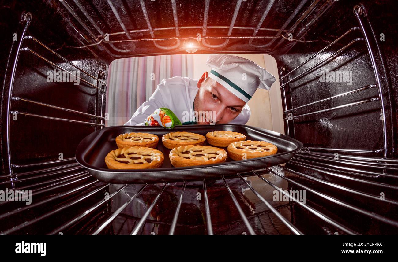 Chef cooking in the oven Stock Photo - Alamy