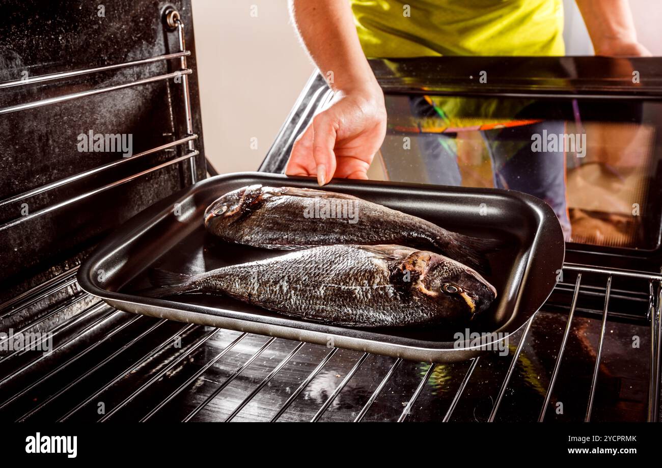 Cooking Dorado fish in the oven Stock Photo - Alamy