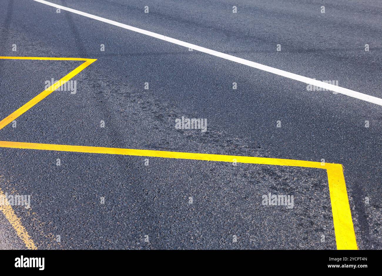 Yellow Bus Stop sign painted on the asphalt closeup Stock Photo - Alamy