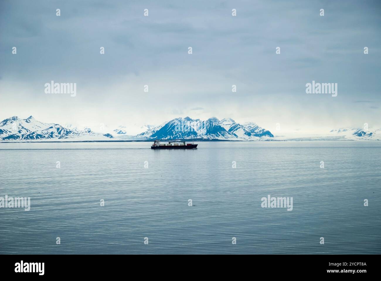 Ship in arctic ocean with snowy mountains behind Stock Photo - Alamy