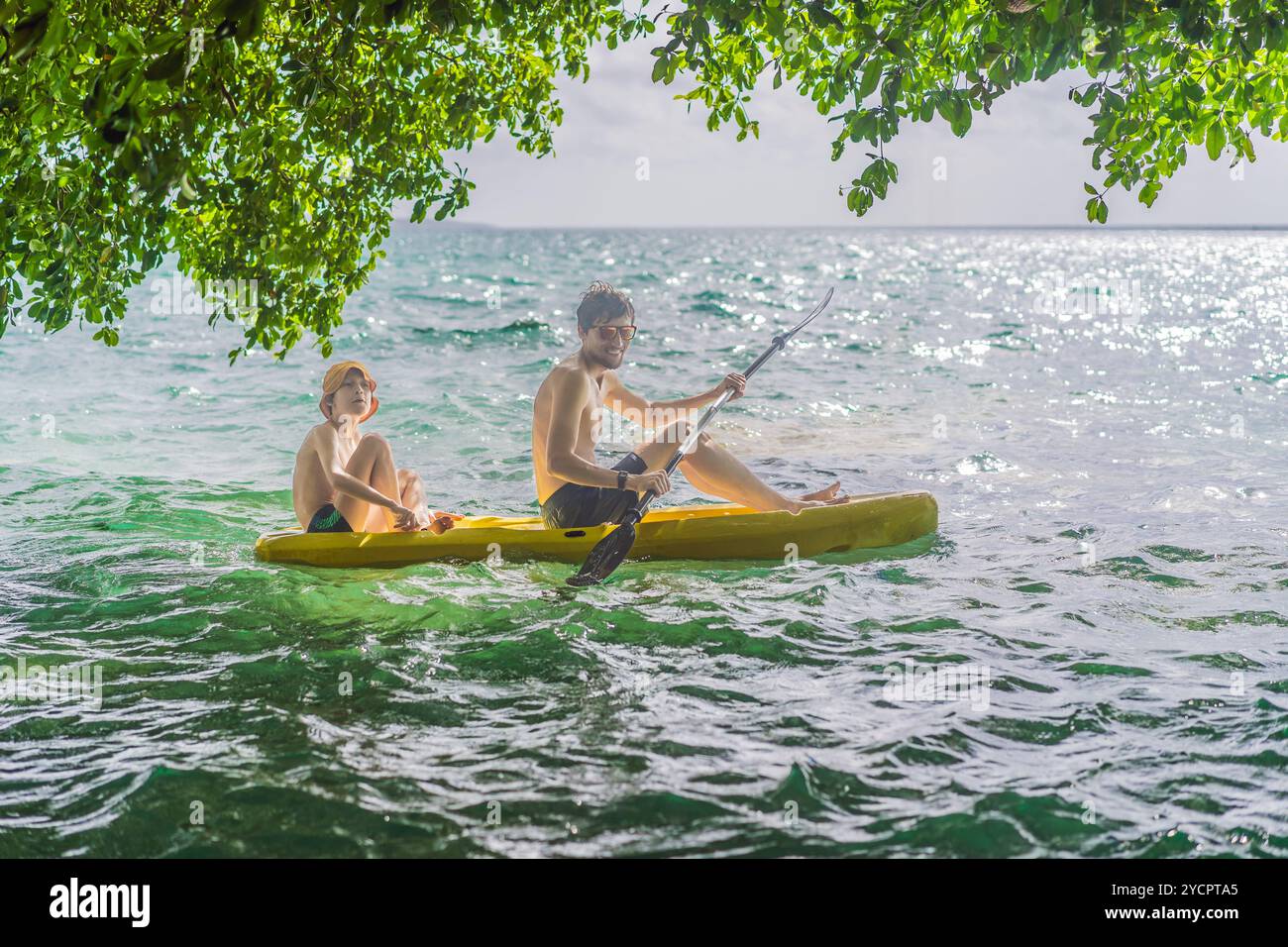Father and son tourists kayaking on Bacalar Lake in Mexico. Adventure ...