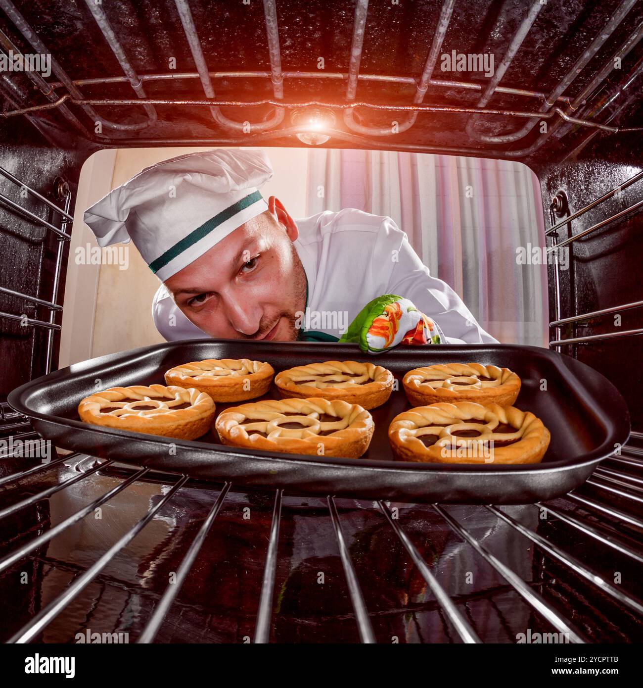 Chef cooking in the oven Stock Photo - Alamy