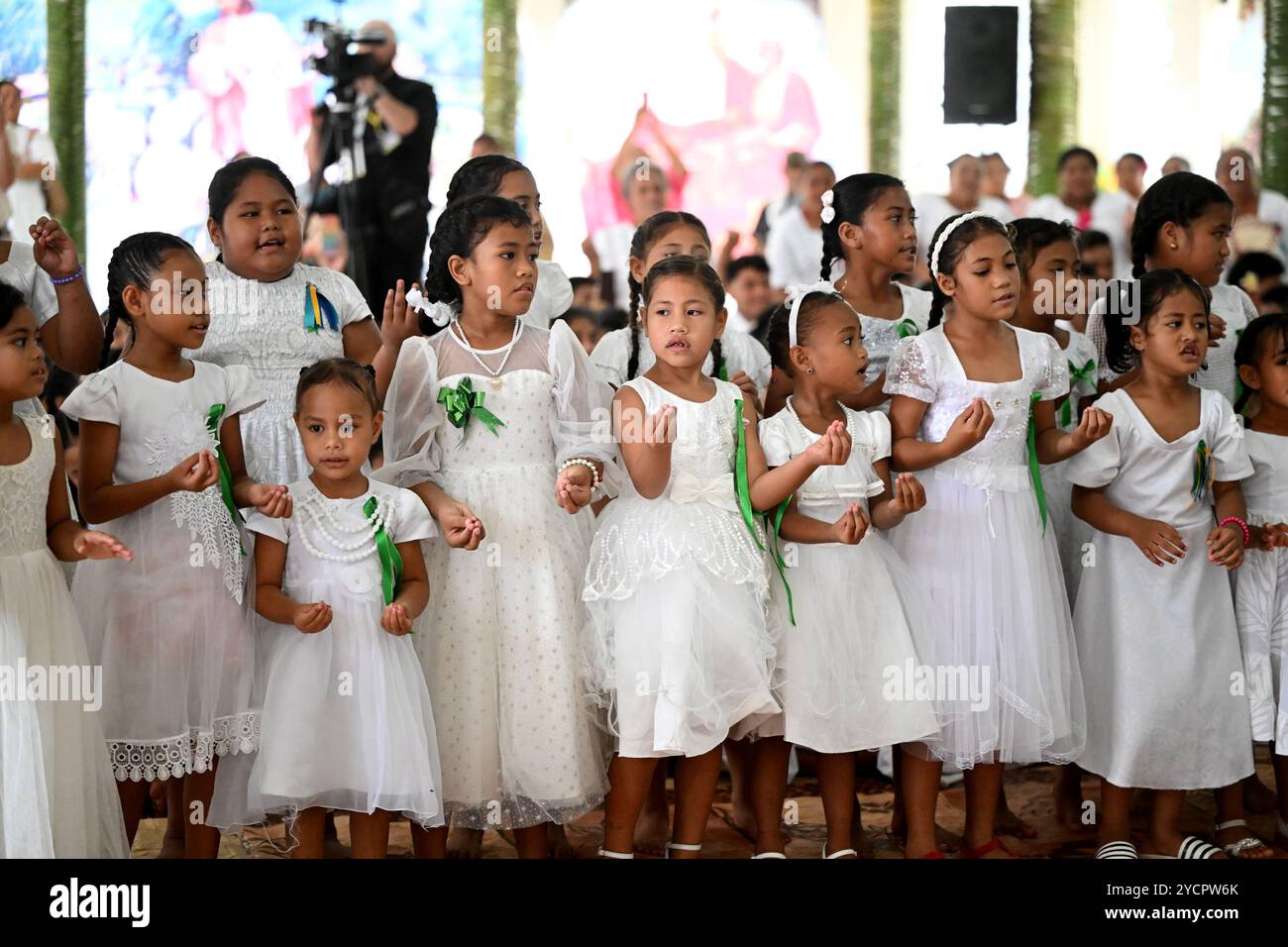 Children await the arrival of King Charles III and Queen Camilla at ...