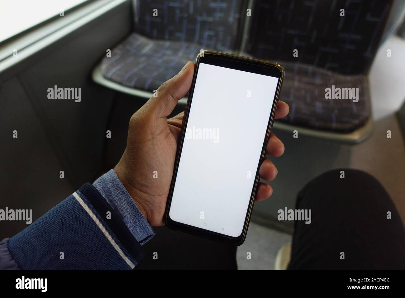 passenger sitting in a bus using his phone Stock Photo - Alamy