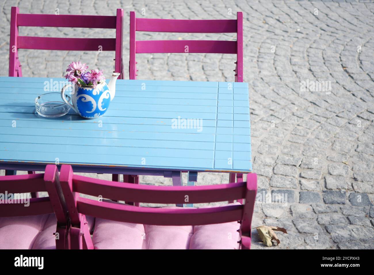 A Beautiful and Colorful Outdoor Cafe Setup Featuring a Charming Table ...