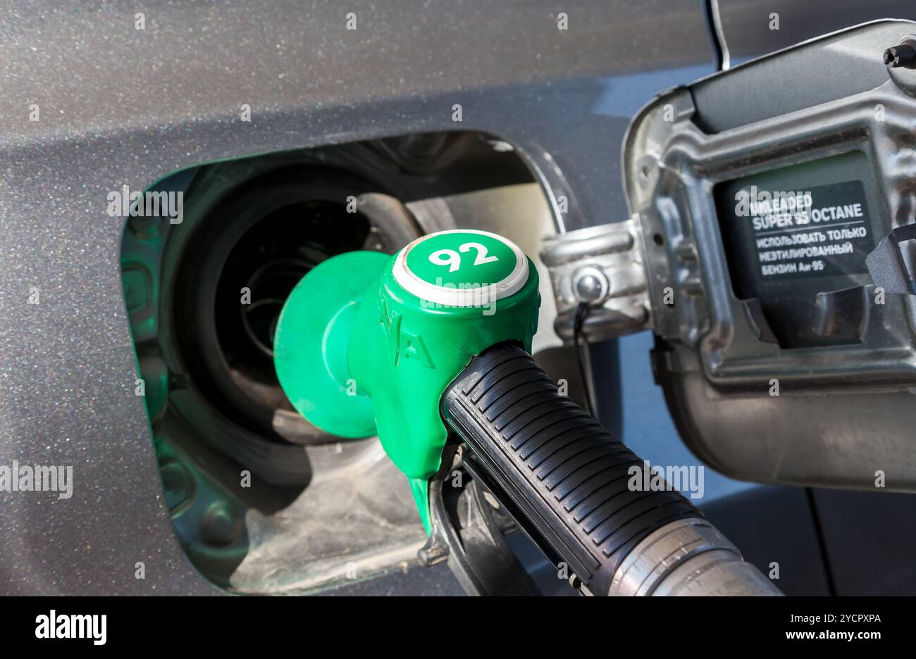 Closeup pumping gasoline fuel in passenger car at gas station Stock ...