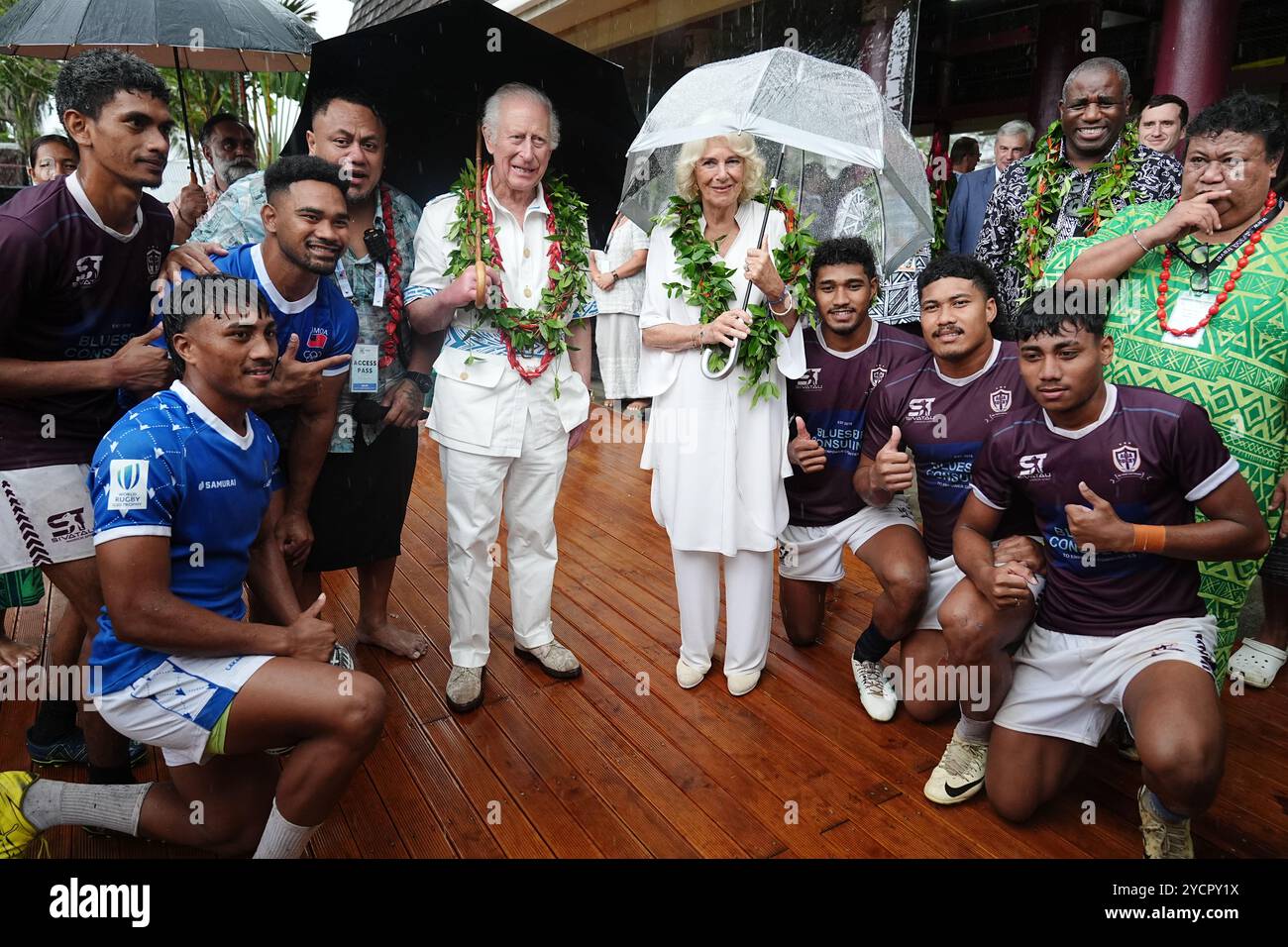 King Charles III and Queen Camilla with members of a rugby team during ...