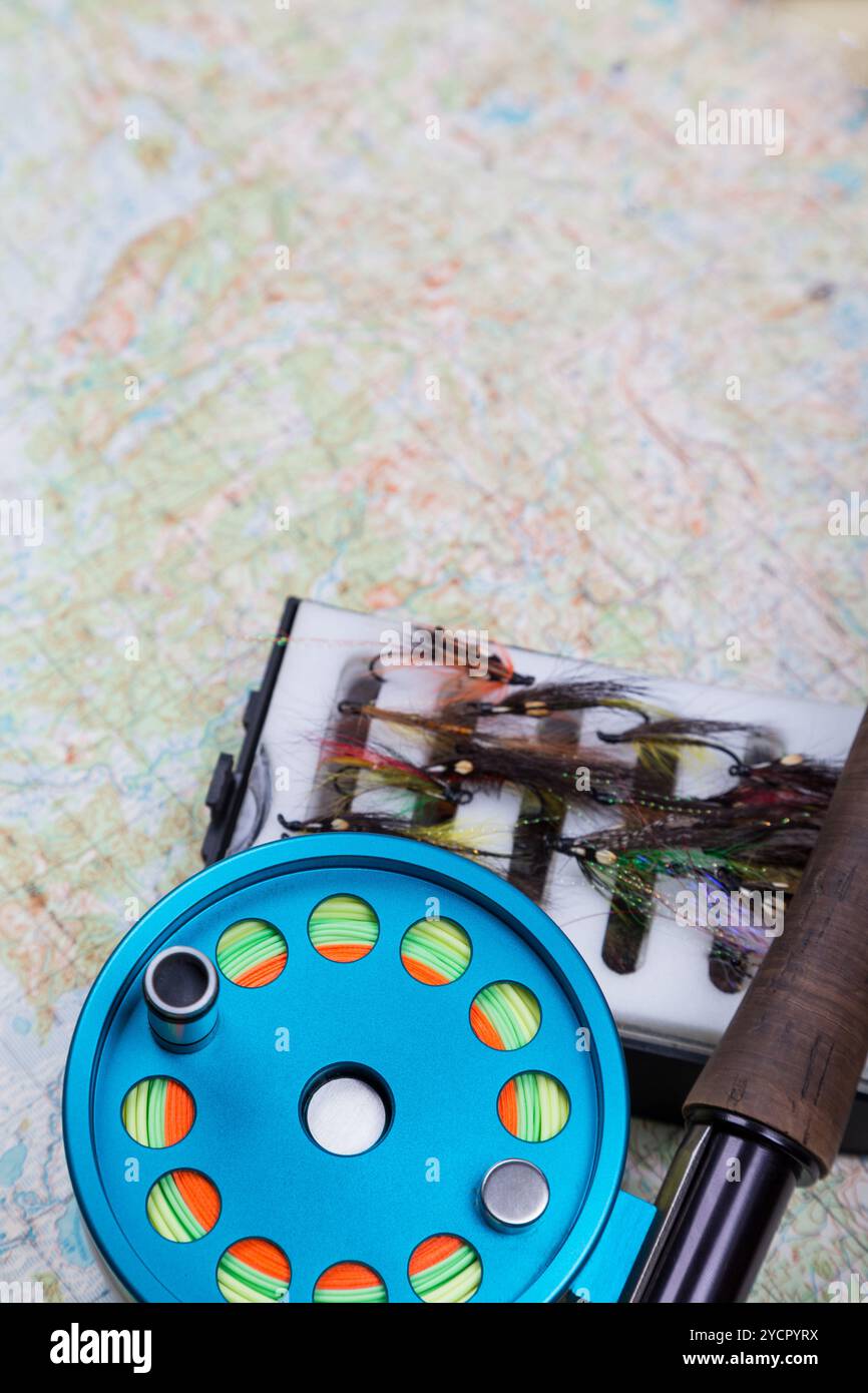 Fishing journey with fly-fishing tackles and map Stock Photo - Alamy