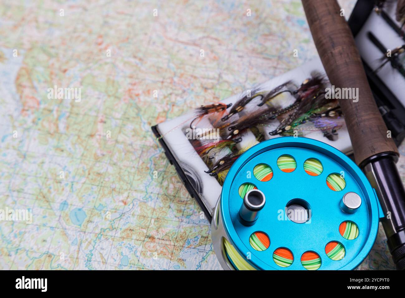 Fishing journey with fly-fishing tackles and map Stock Photo - Alamy