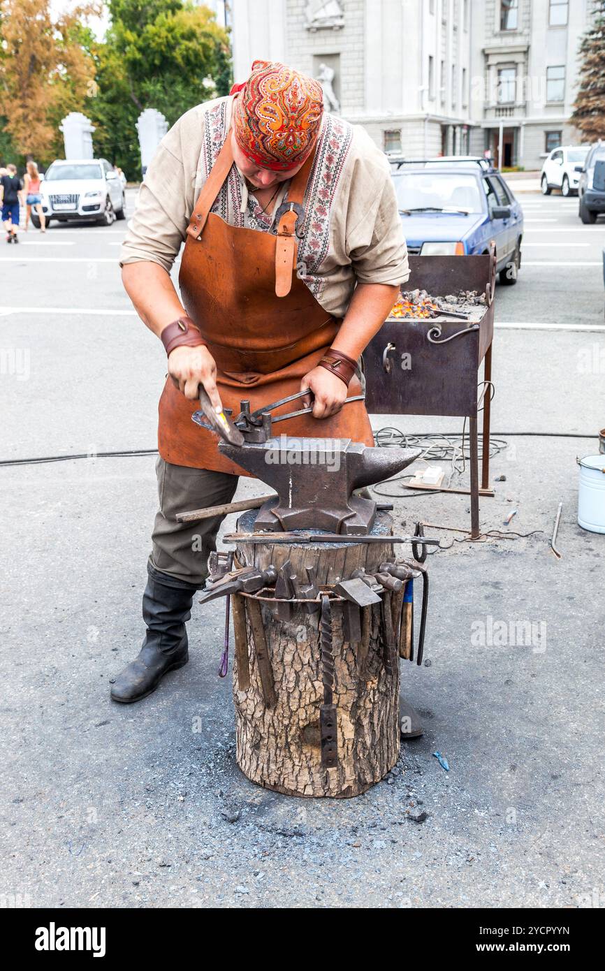 Blacksmith handles the horseshoe on the anvil at the outdoors Stock ...