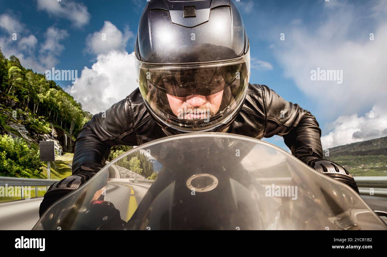 Biker racing on the road Stock Photo - Alamy