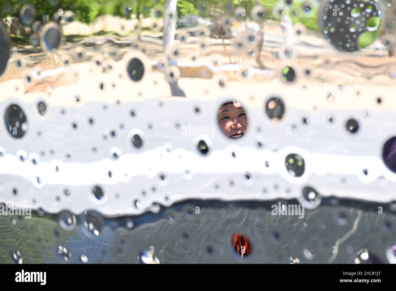 Canberra, Australia. 24th Oct, 2024. Artist Lindy Lee is seen through ...