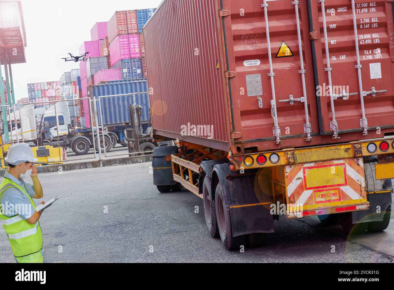 Trucks in the container storage yard Stock Photo - Alamy
