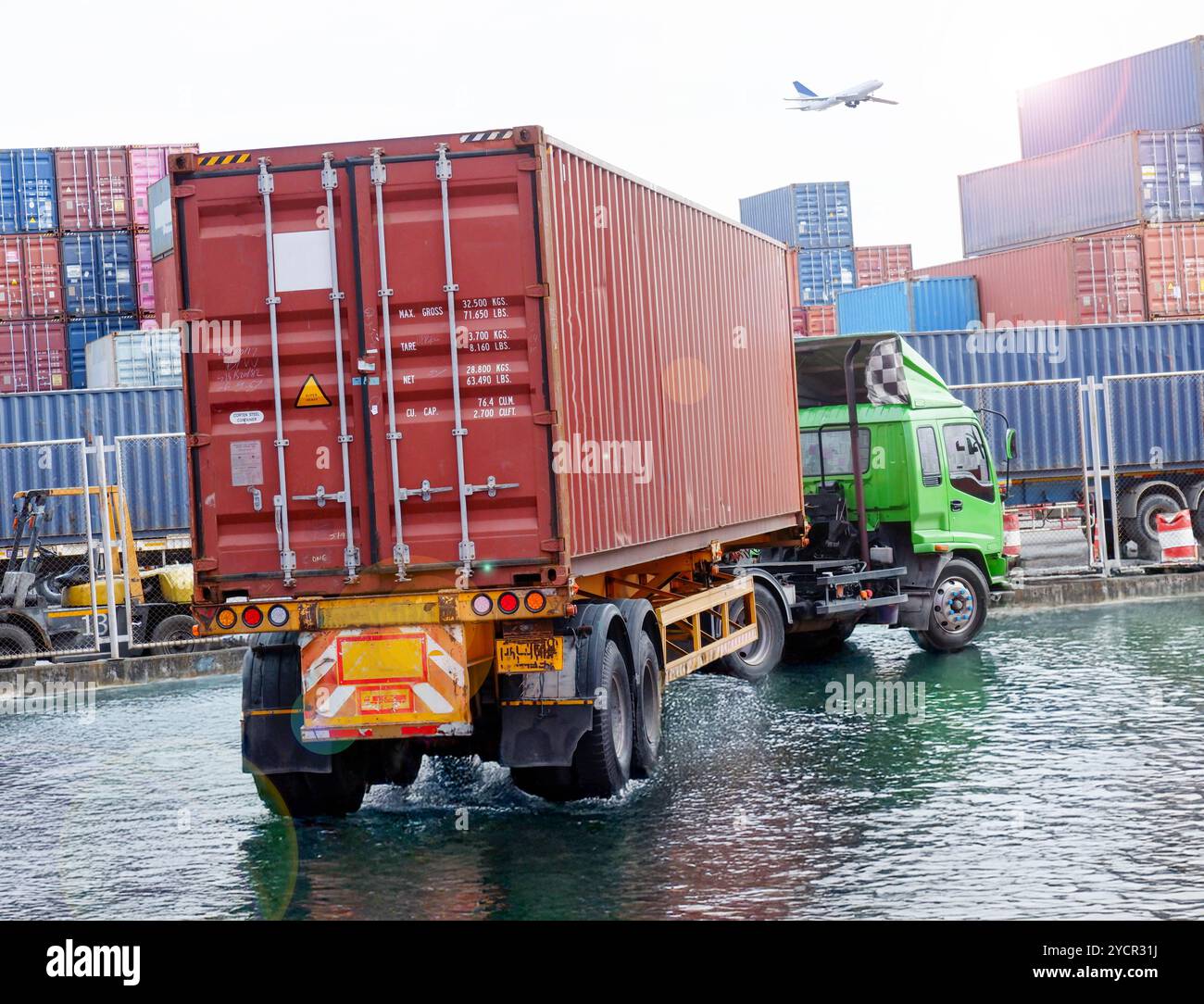 Trucks in the container storage yard Stock Photo - Alamy
