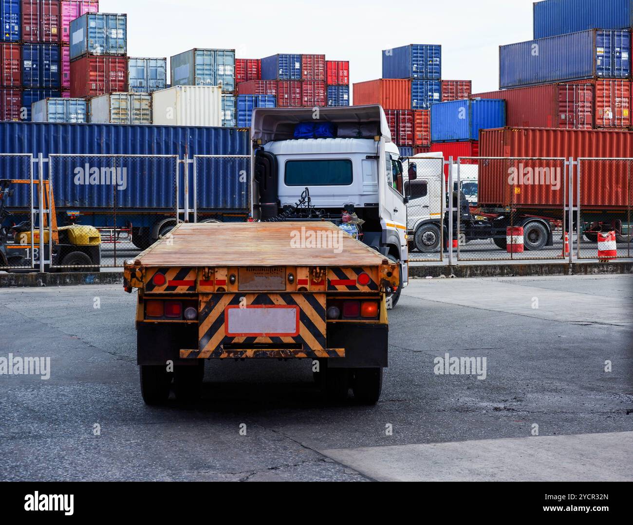 Trucks in the container storage yard Stock Photo - Alamy