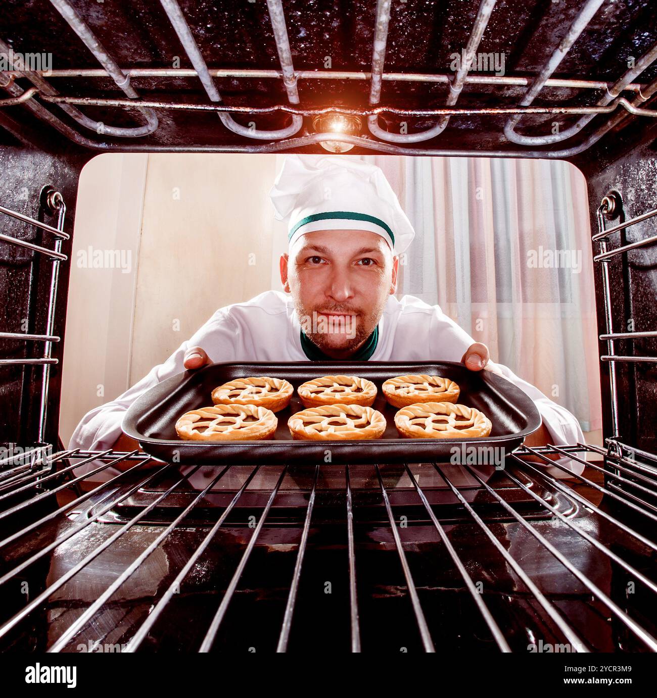 Chef cooking in the oven Stock Photo - Alamy