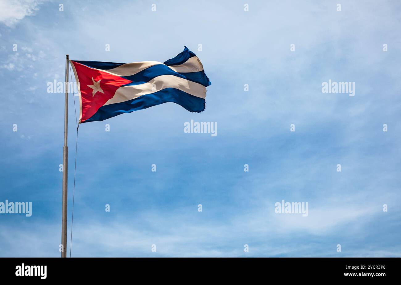 Cuban flag flying in the wind on a backdrop of blue sky Stock Photo - Alamy