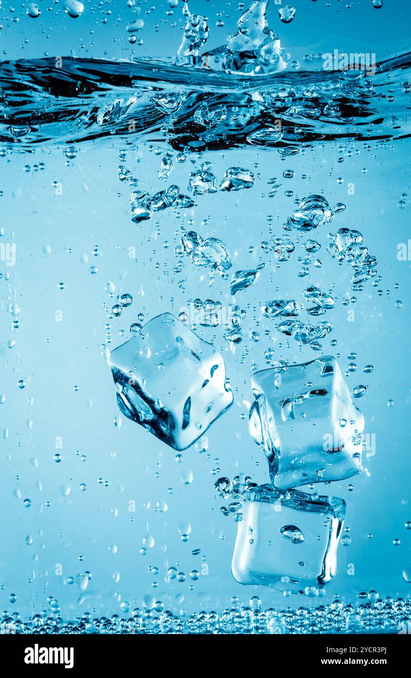 Ice cubes falling under water Stock Photo - Alamy