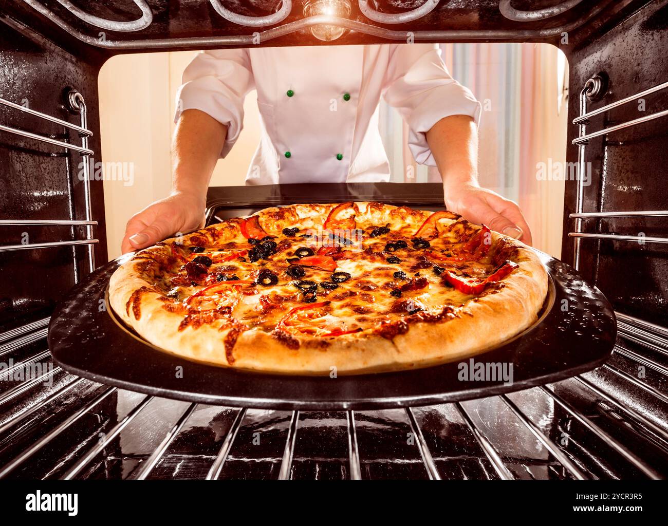 Chef cooking pizza in the oven Stock Photo - Alamy
