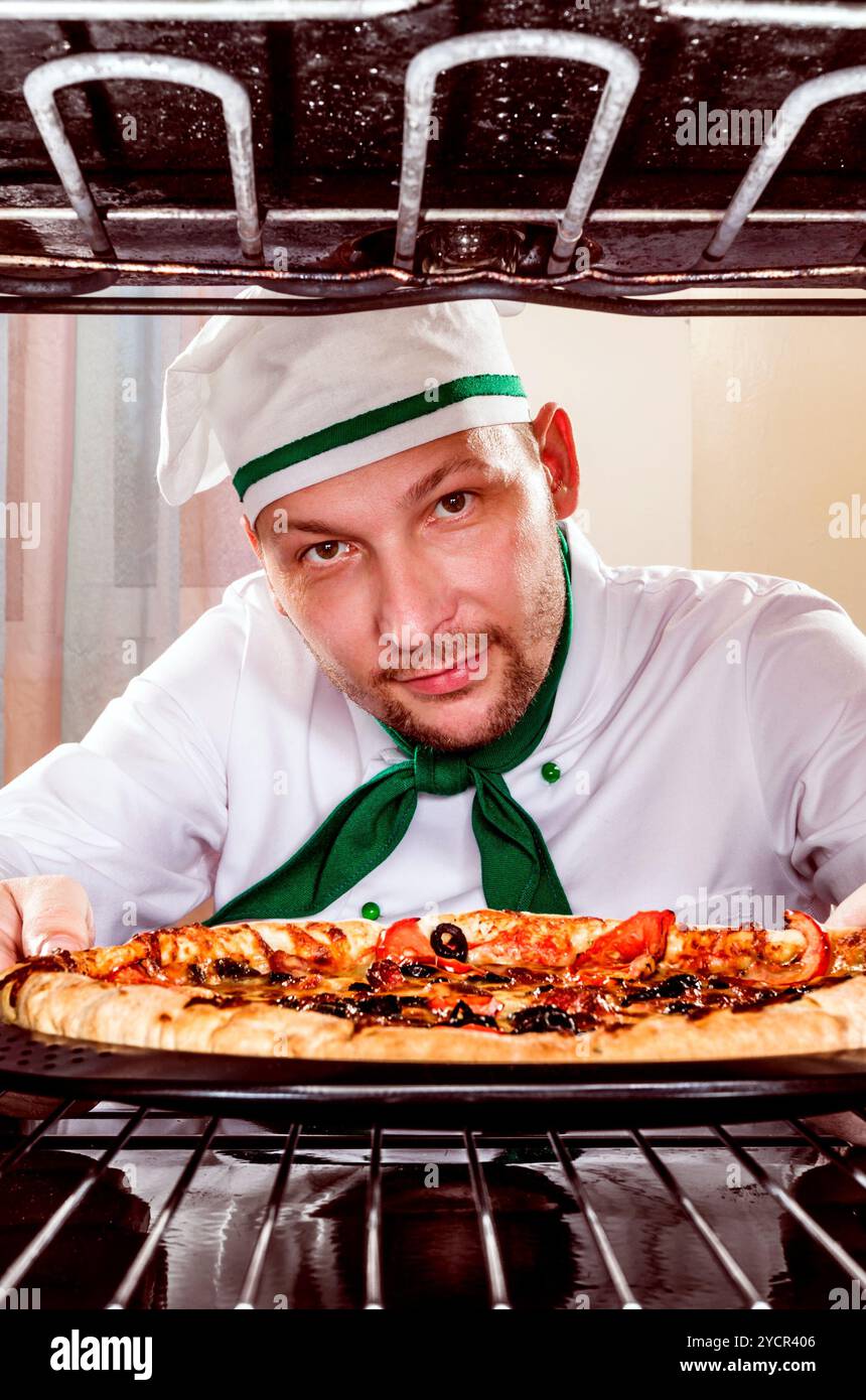 Chef cooking pizza in the oven Stock Photo - Alamy