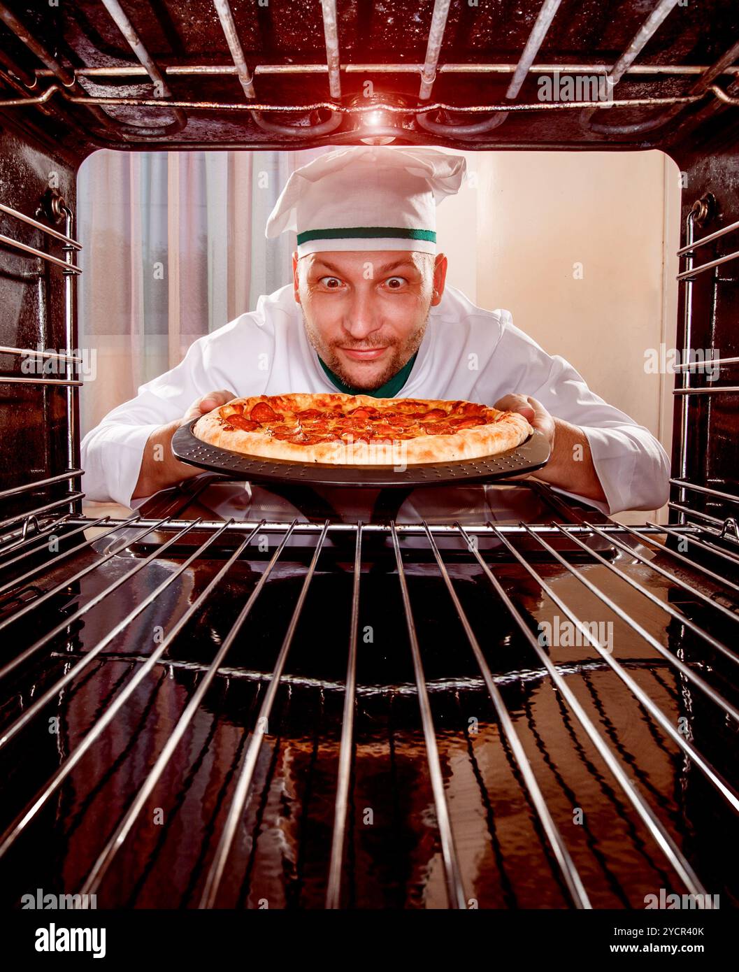 Chef prepares pizza in the oven, view from the inside of the oven ...