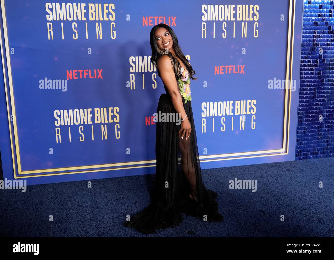 U.S. Olympic gymnast Simone Biles turns back for photographers at the ...