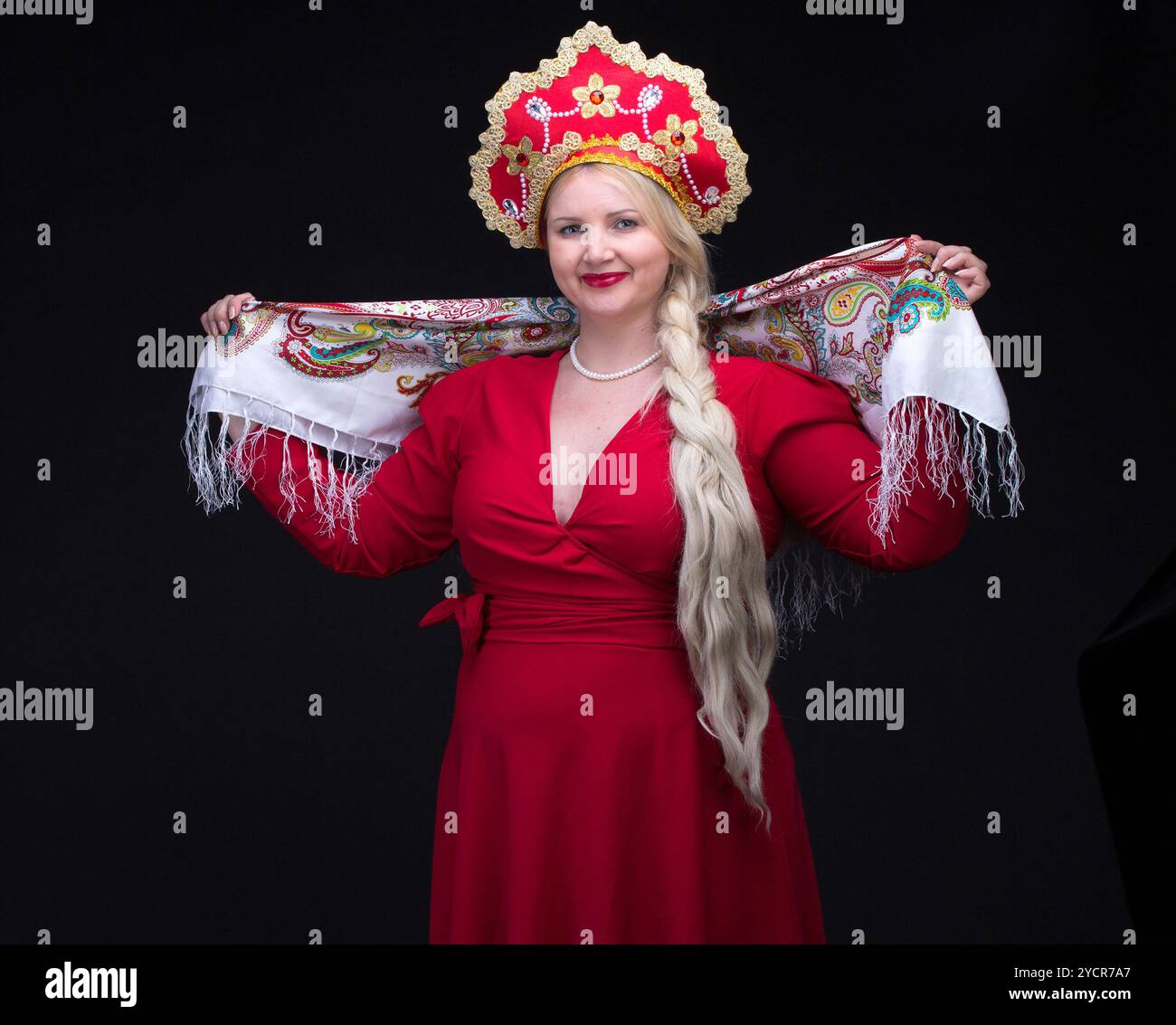 Girl standing in Russian traditional costume. Woman is wearing sarafan ...