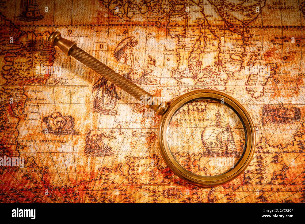 Vintage magnifying glass lies on an ancient world map Stock Photo - Alamy