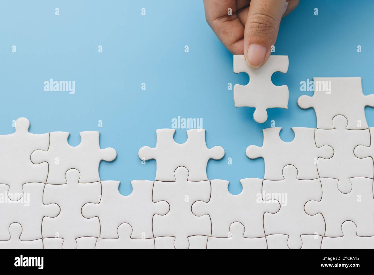 Hand push last piece jigsawto finish success planning concept solve ...