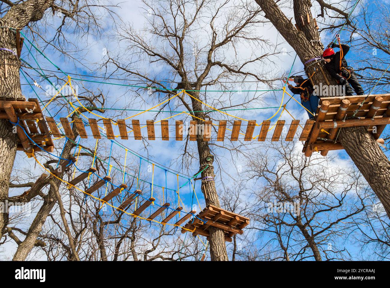 Boy and girl with climbing equipment ready for the passage of obstacles ...