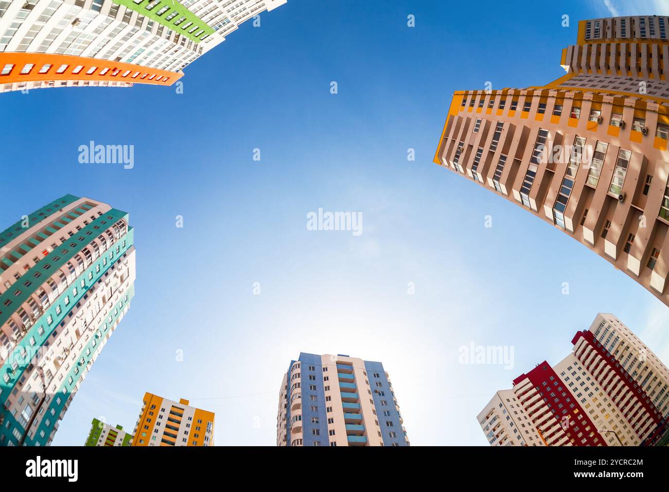 Fisheye view on the new tall apartment buildings against blue sky ...