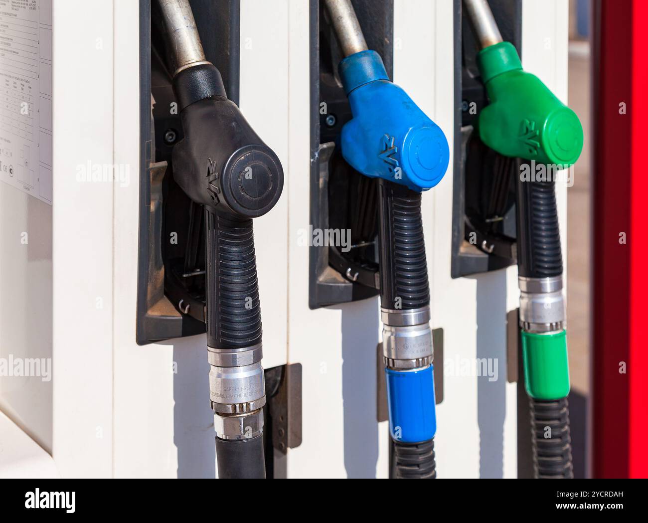Gas pump nozzles with different fuels at the gas station Stock Photo ...