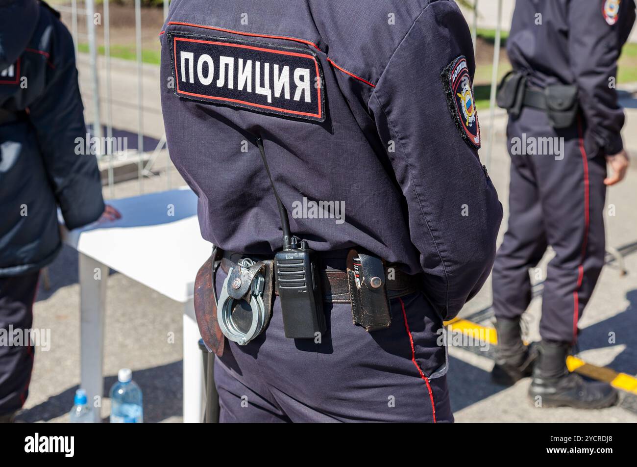 Equipment on the belt of Russian policeman. Text in russian: Police ...