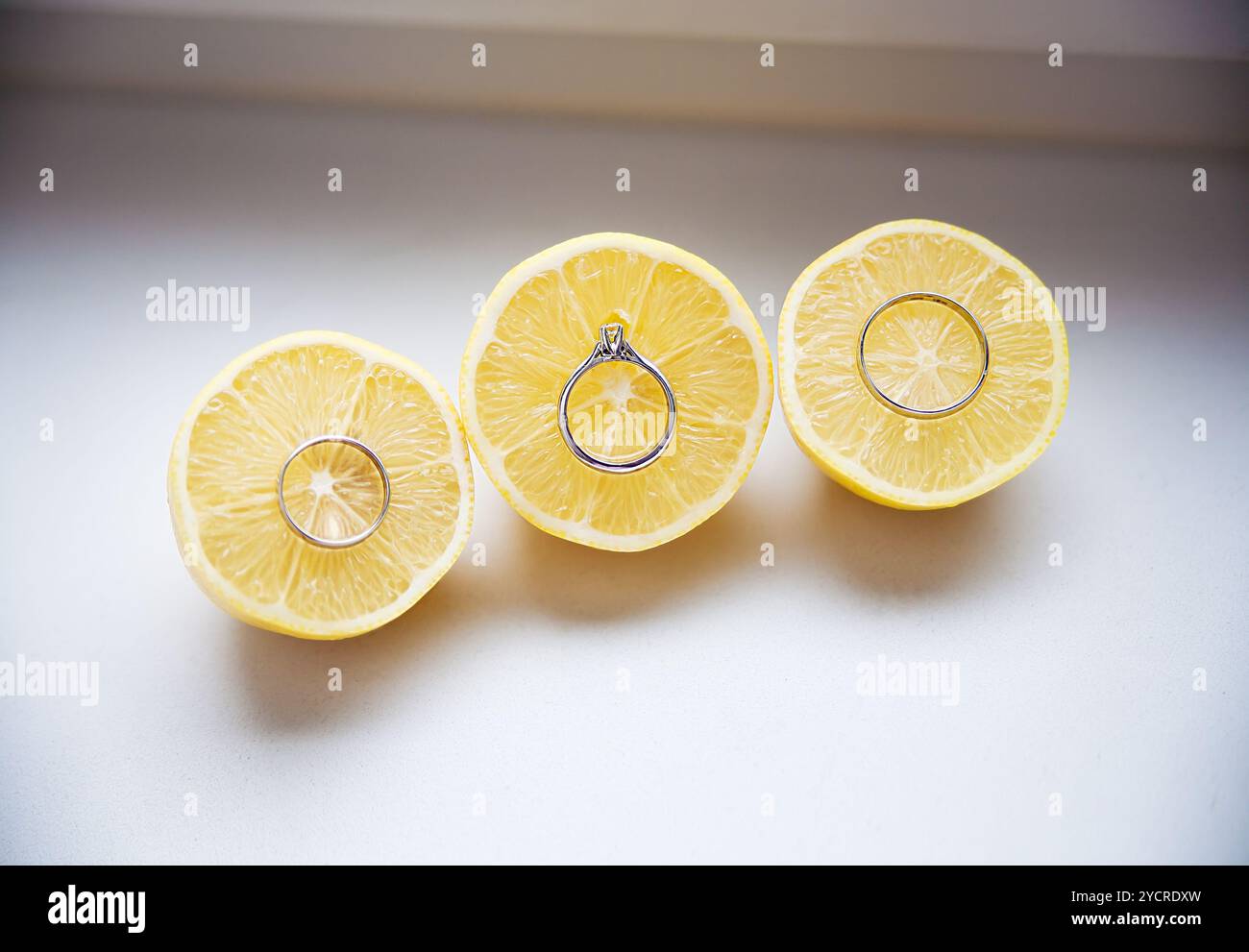 Lemon with wedding rings Stock Photo - Alamy