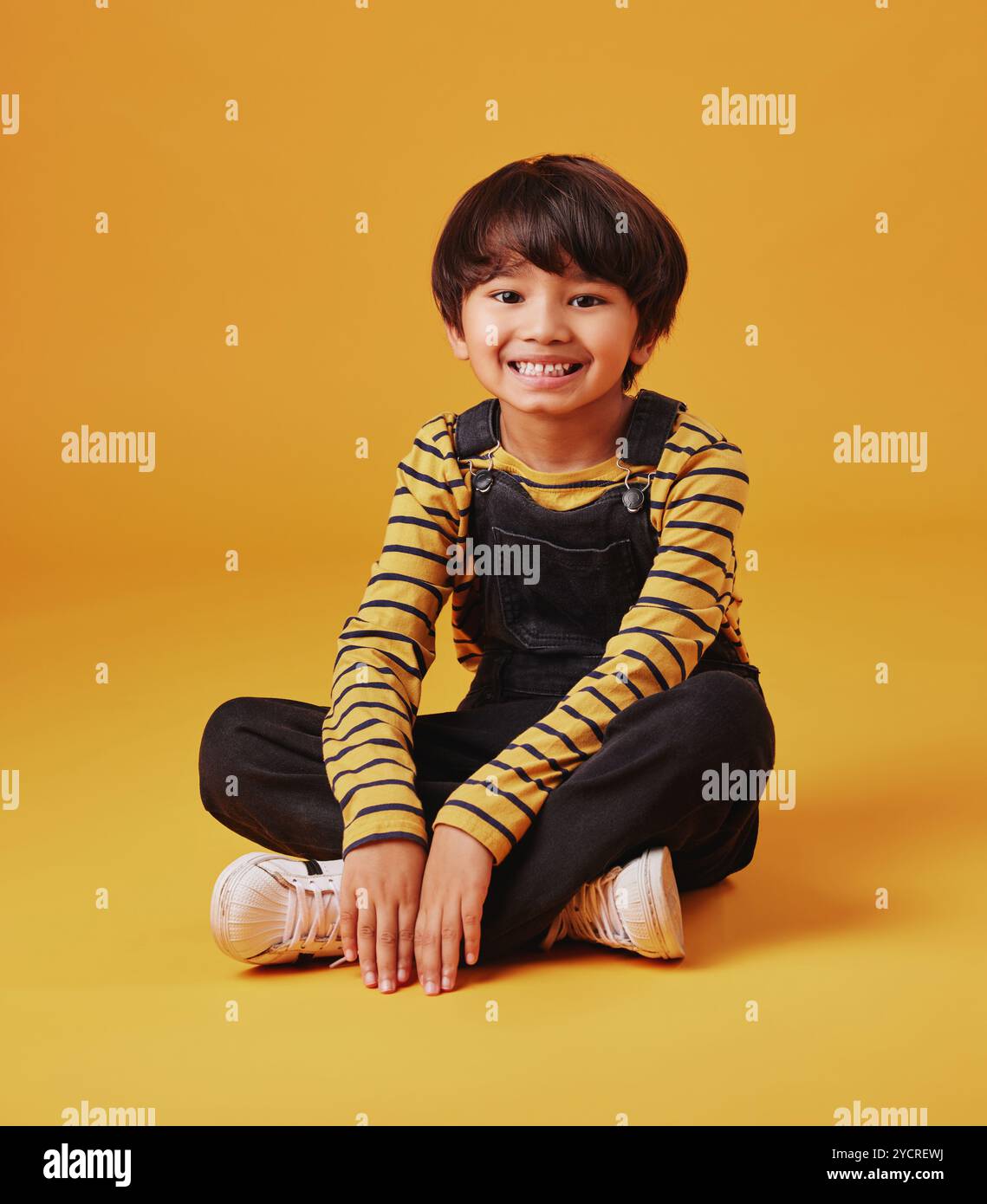 Japanese boy, floor and happy in studio background for fashion with fun ...