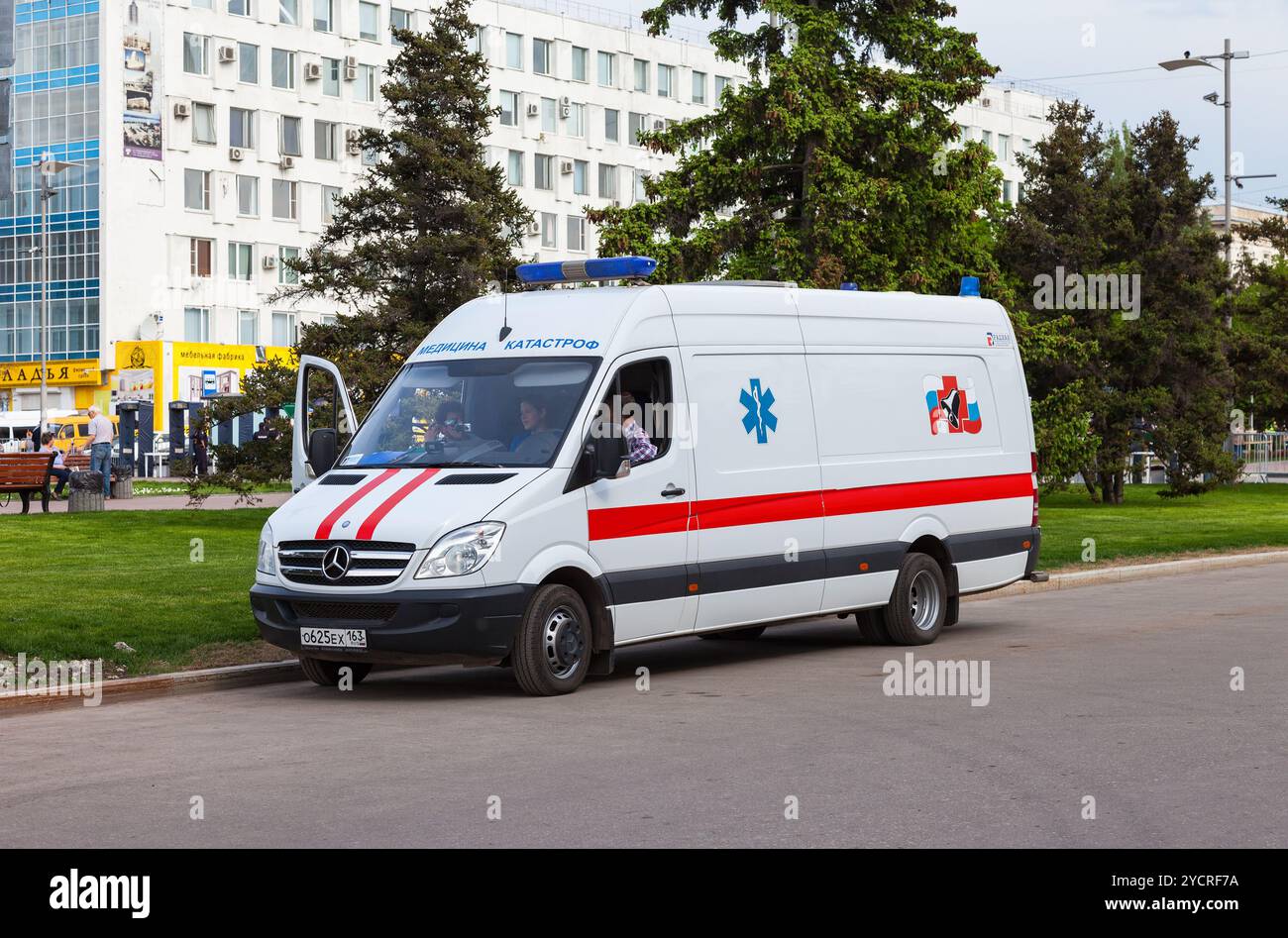 Ambulance car parked up in the street. Text in russian: Emergency ...