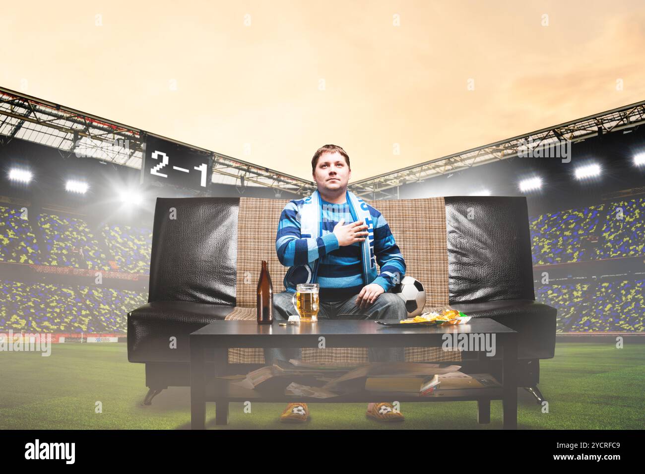 Football fan on sofa at stadium Stock Photo - Alamy