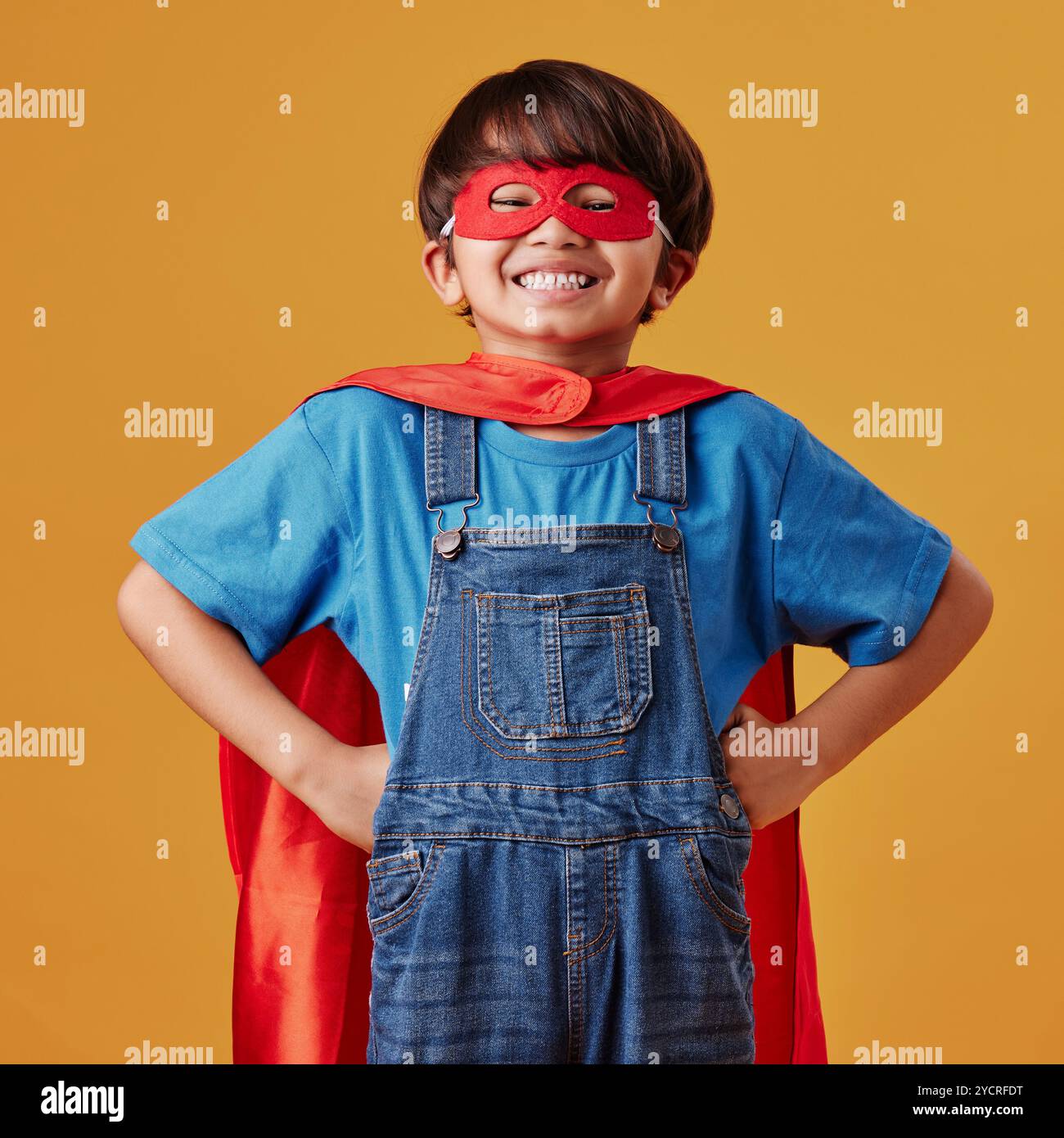 Boy, portrait and superhero costume on studio background, confident and ...